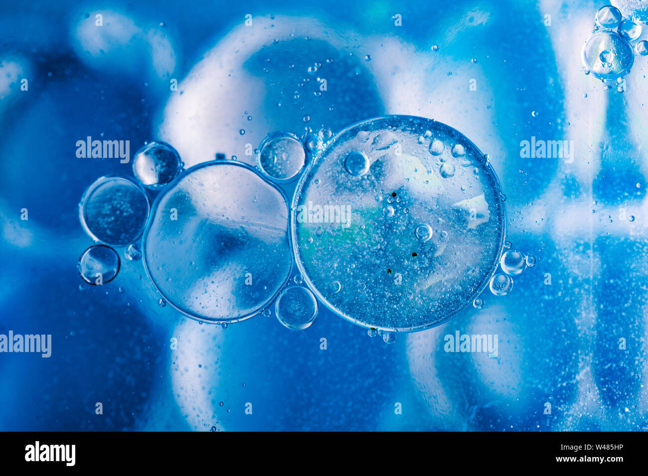 Oil bubbles inside water base form patterns Stock Photo - Alamy