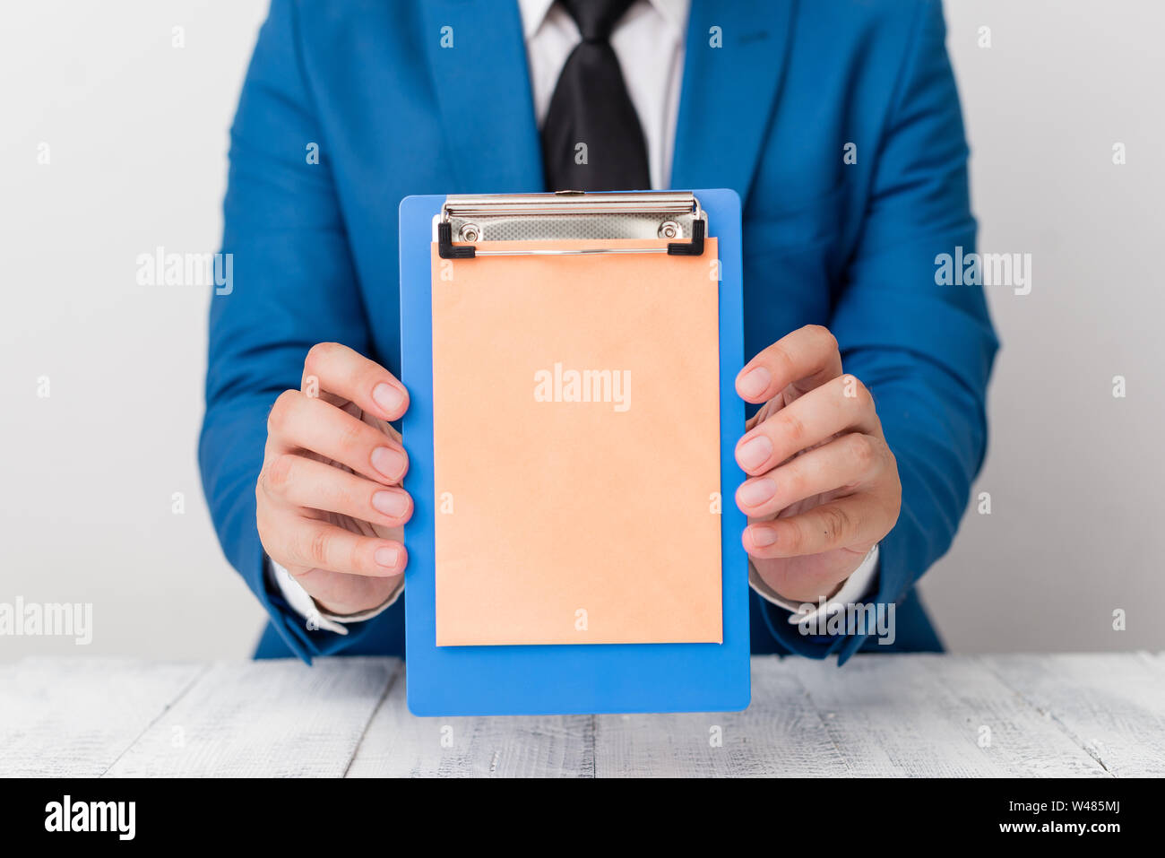 Man holds empty paper with copy space in front of him. White space for ...