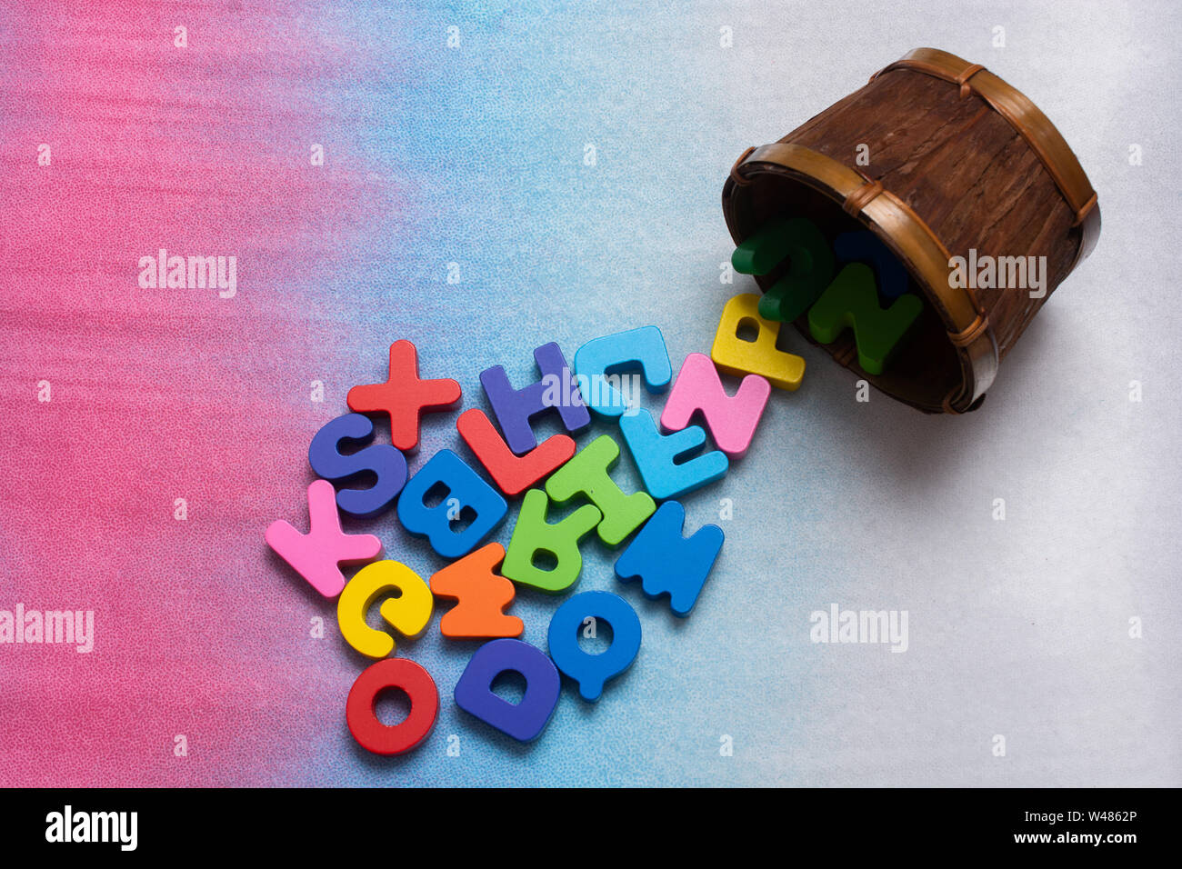 Colorful wooden letters in a container on a colorful background Stock ...