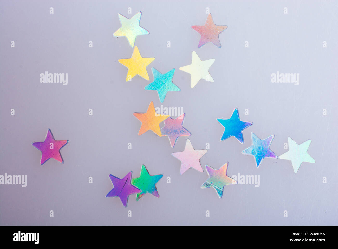 Star shaped bright paper on a blue fabric background Stock Photo - Alamy