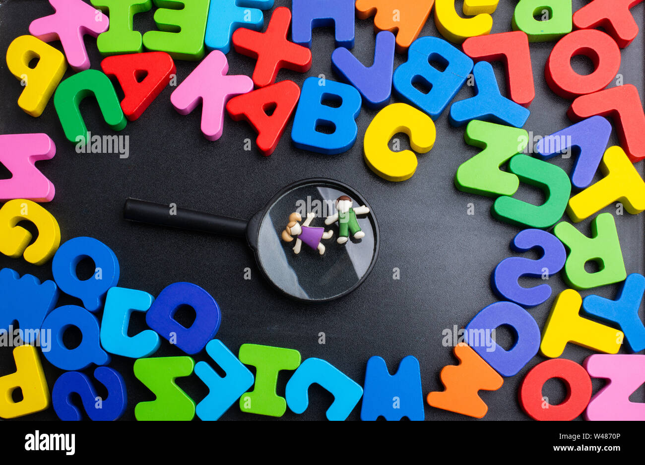 Kids over Magnifying glass and Colorful Letters of Alphabet Stock Photo ...