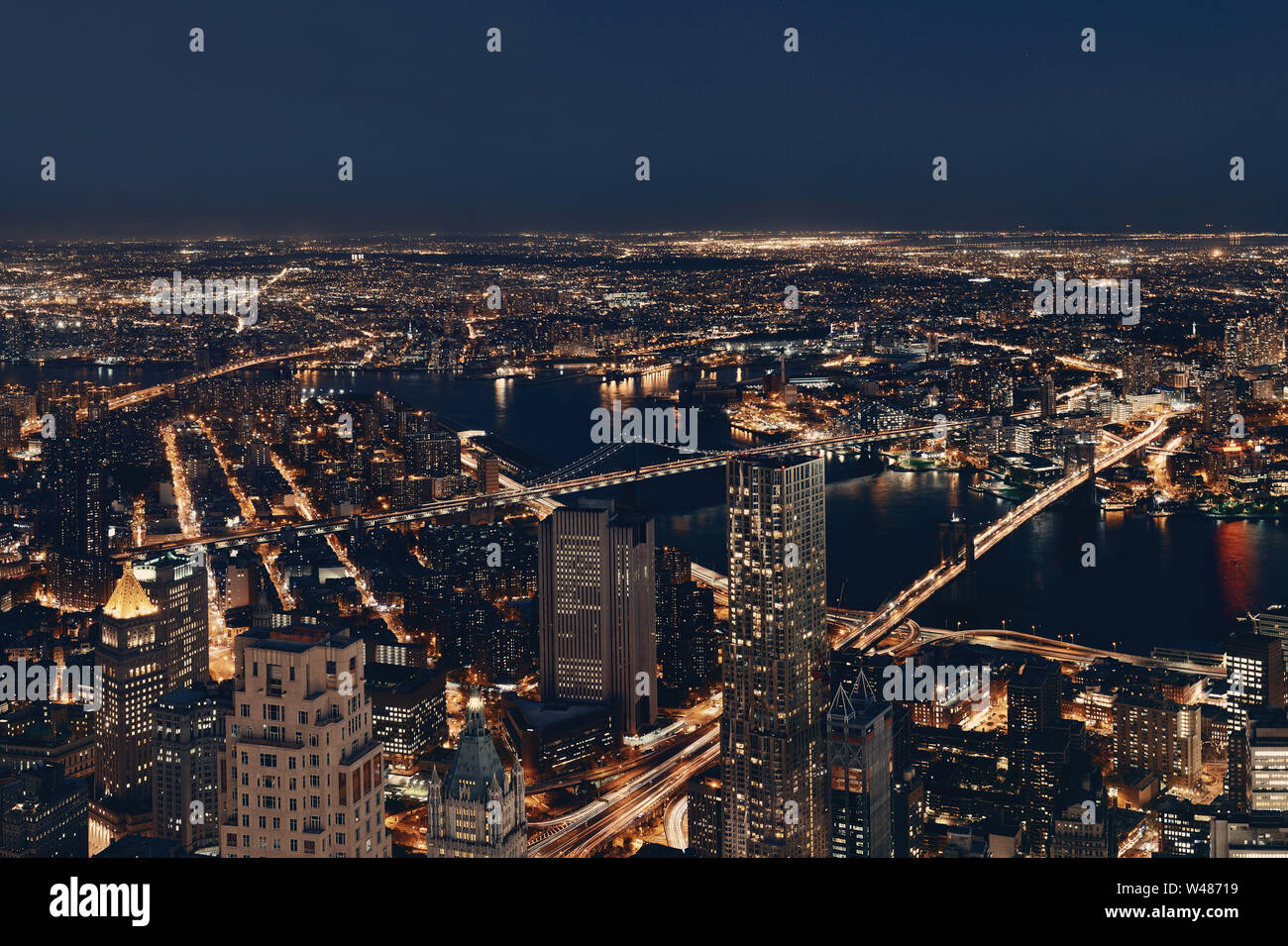 Rooftop night view of New York City downtown with urban skyscrapers ...
