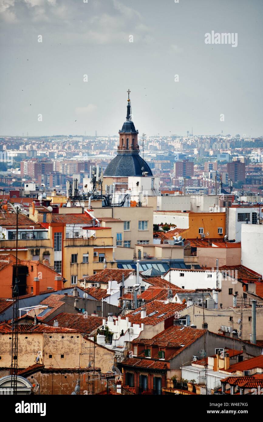 Madrid skyline rooftop view with buildings and church bell tower in ...