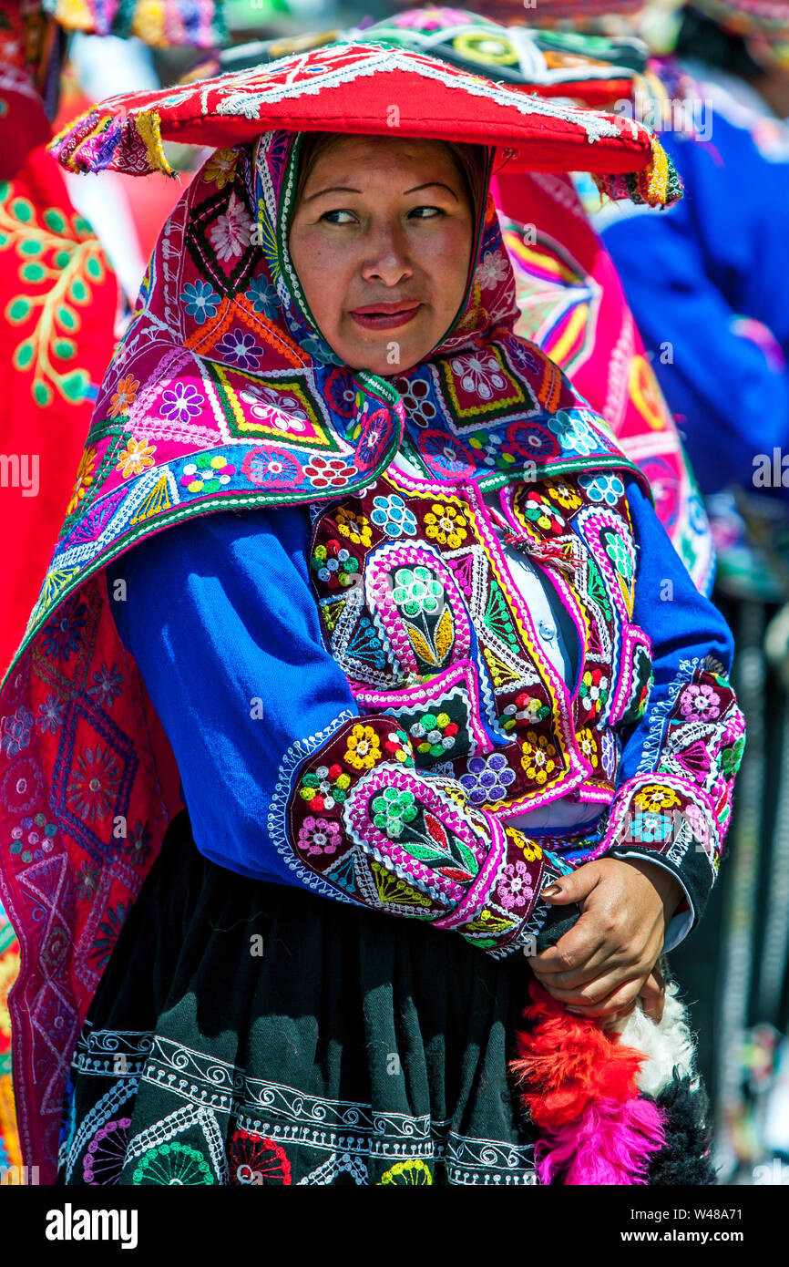 A lady dressed in Peruvian costume waits to perform at Plaza de Armas ...