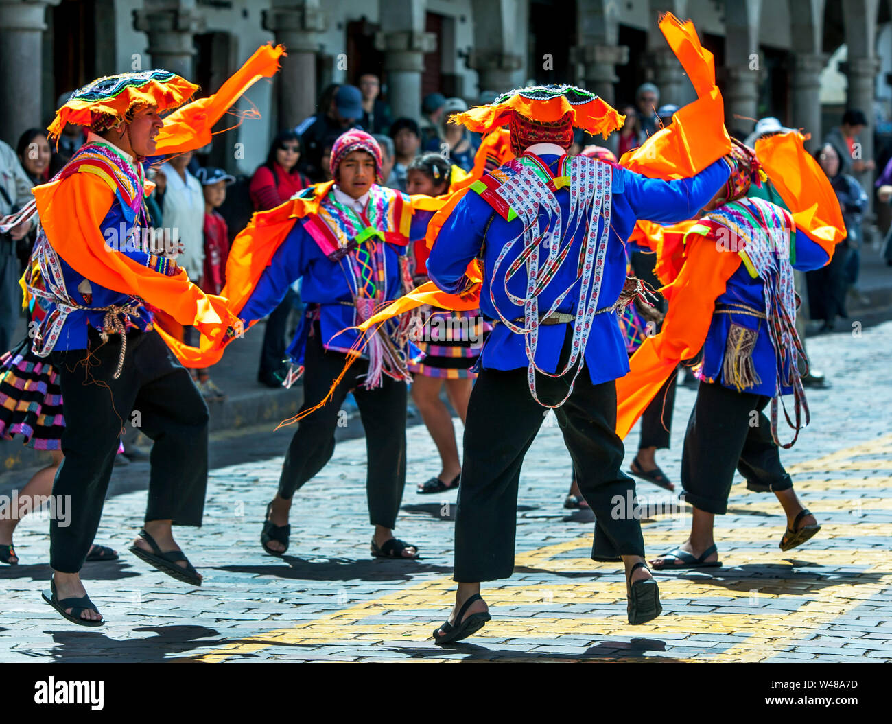Colourfully dressed male performers dance at Plaza de Armas at Cusco in ...