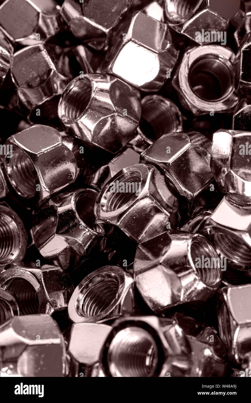 Chromed screw nuts from above. Many screw nuts. Screw nuts of different ...