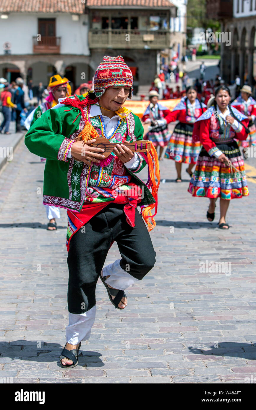 A musician in Peruvian costume with an imitation guitar performs at ...