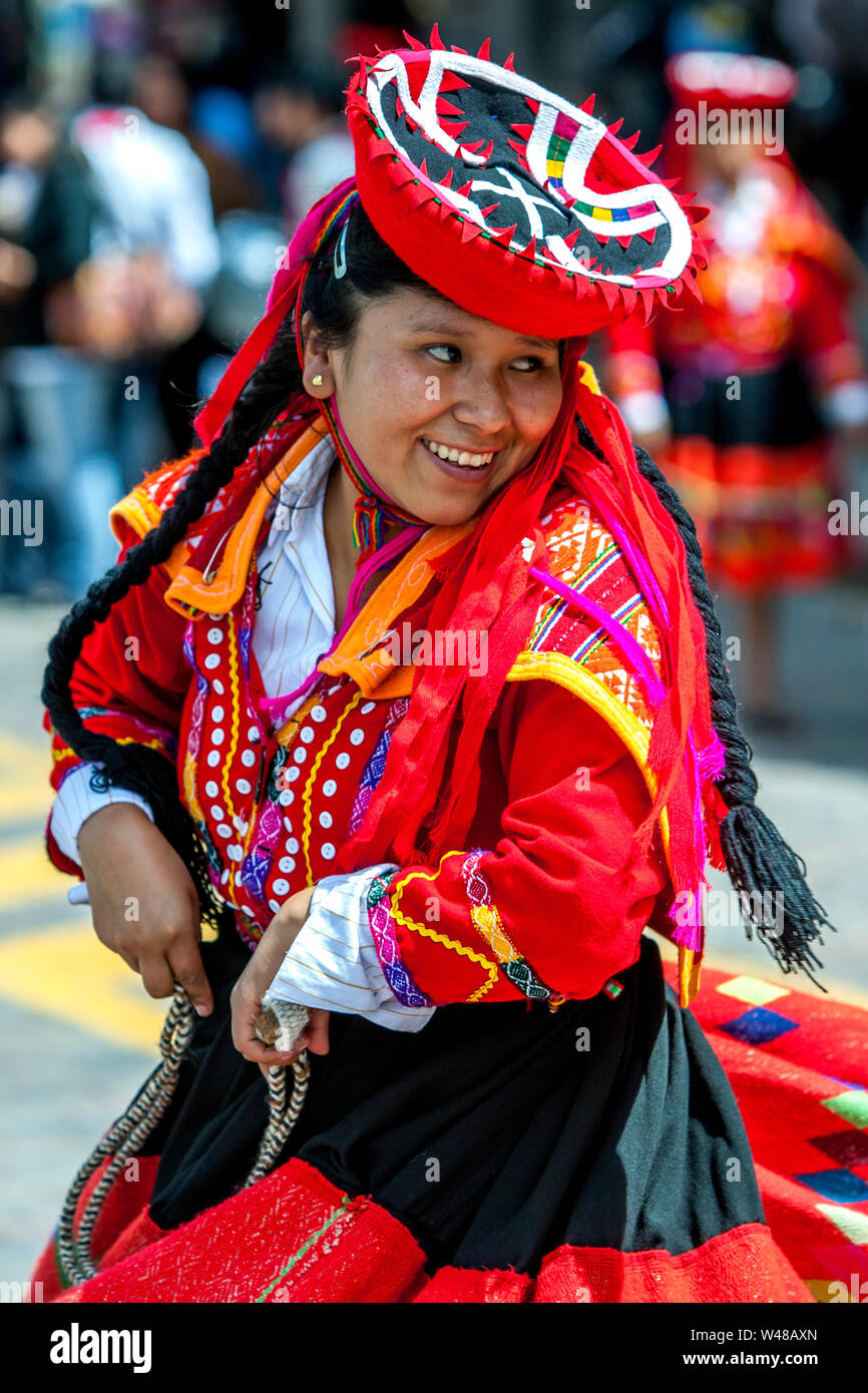 A smiling lady dressed in colourful Peruvian costume performs at Plaza ...