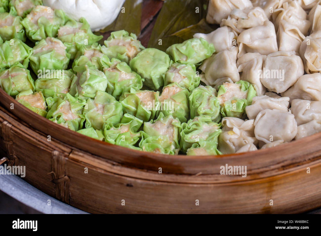 Fresh dim sum in bamboo steamer, chinese cuisine for sale at a local ...
