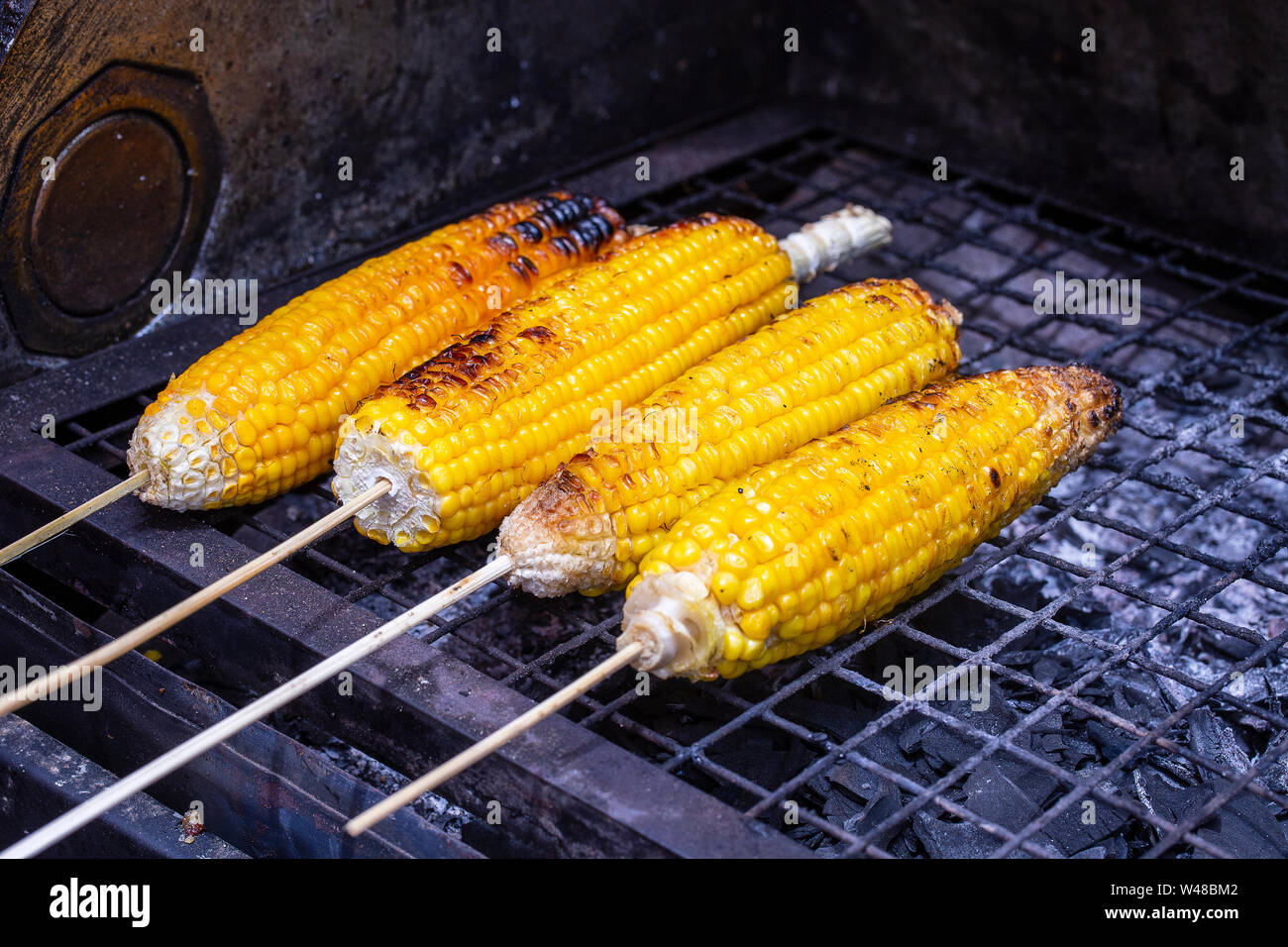 Grilled corn cob in market, street food in Bali, Indonesia. Close up ...