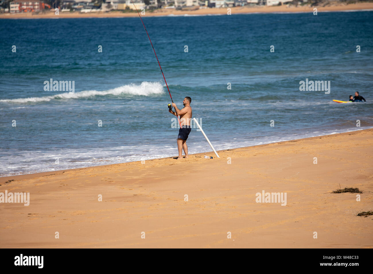 Australian man beach ocean fishing at narrabeen beach in Sydney ...