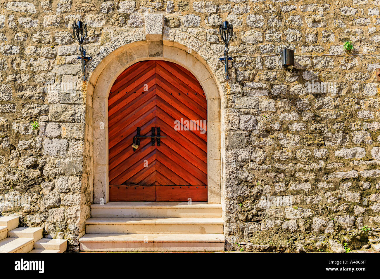 Old wooden entrance gate amd stone steps of the ancient Citadel ...