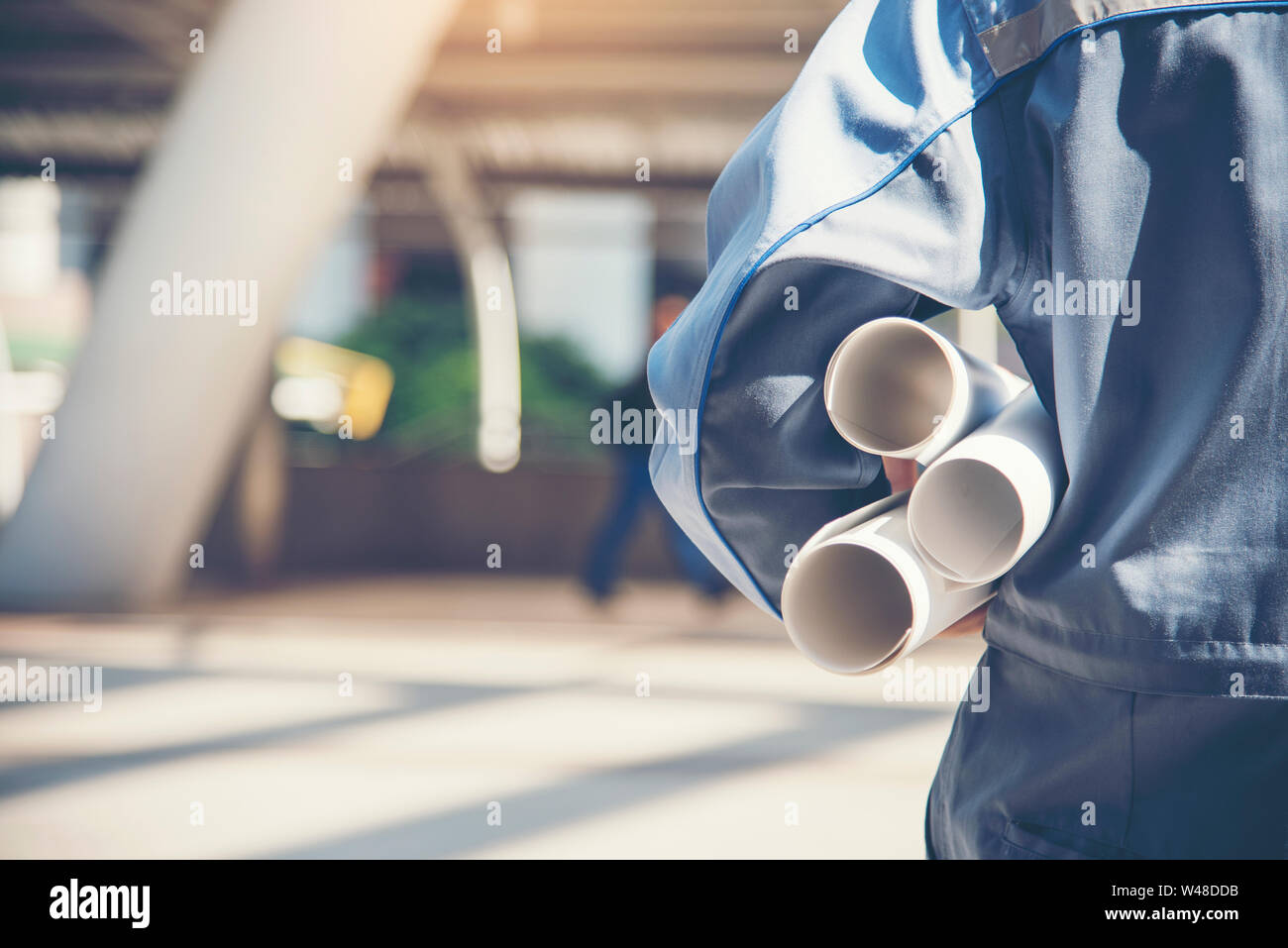 Smart Engineer wear bear suit holding building plan on hand at the ...