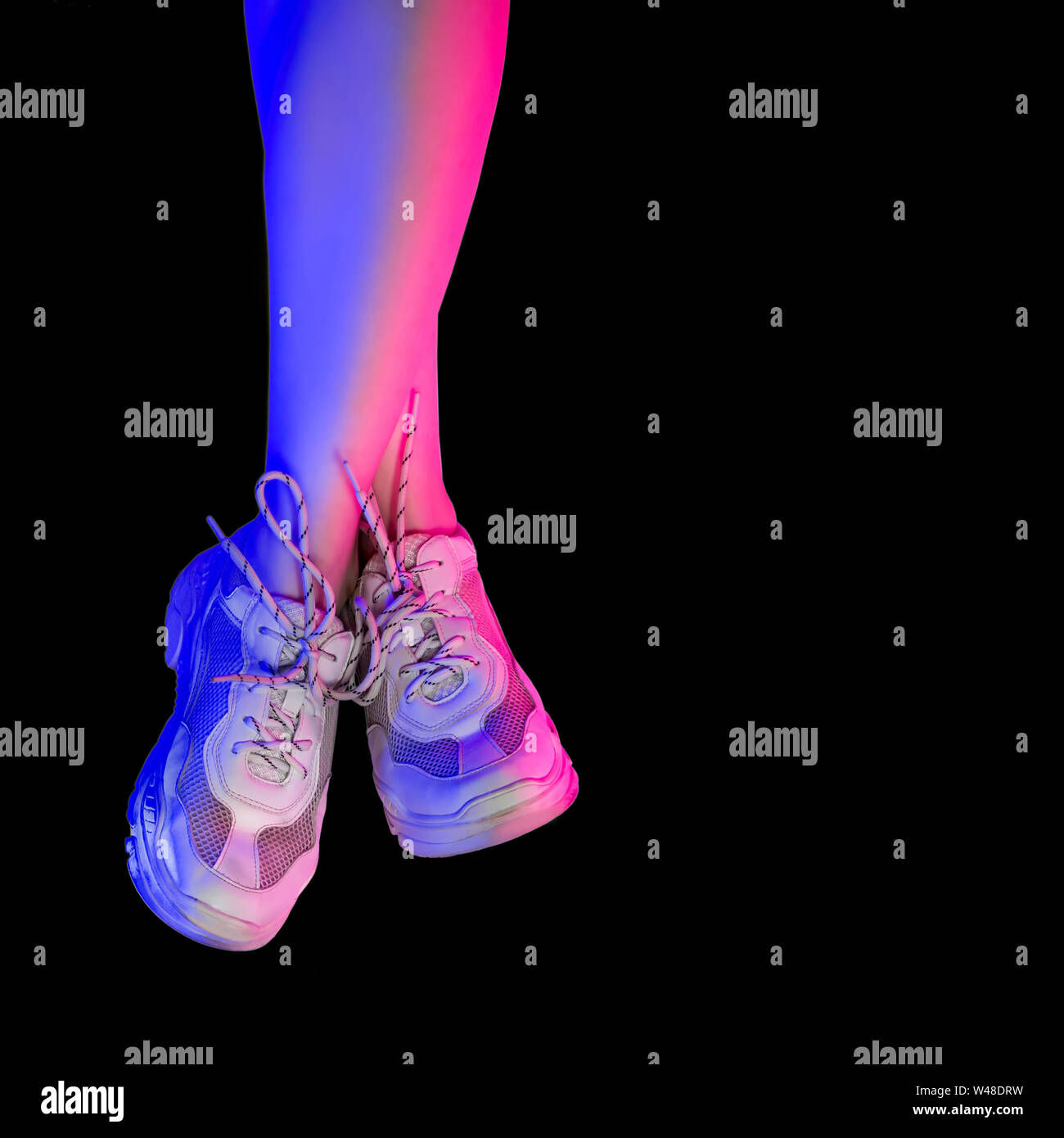 Slender female legs in white sneakers. Trend neon lights Stock Photo ...