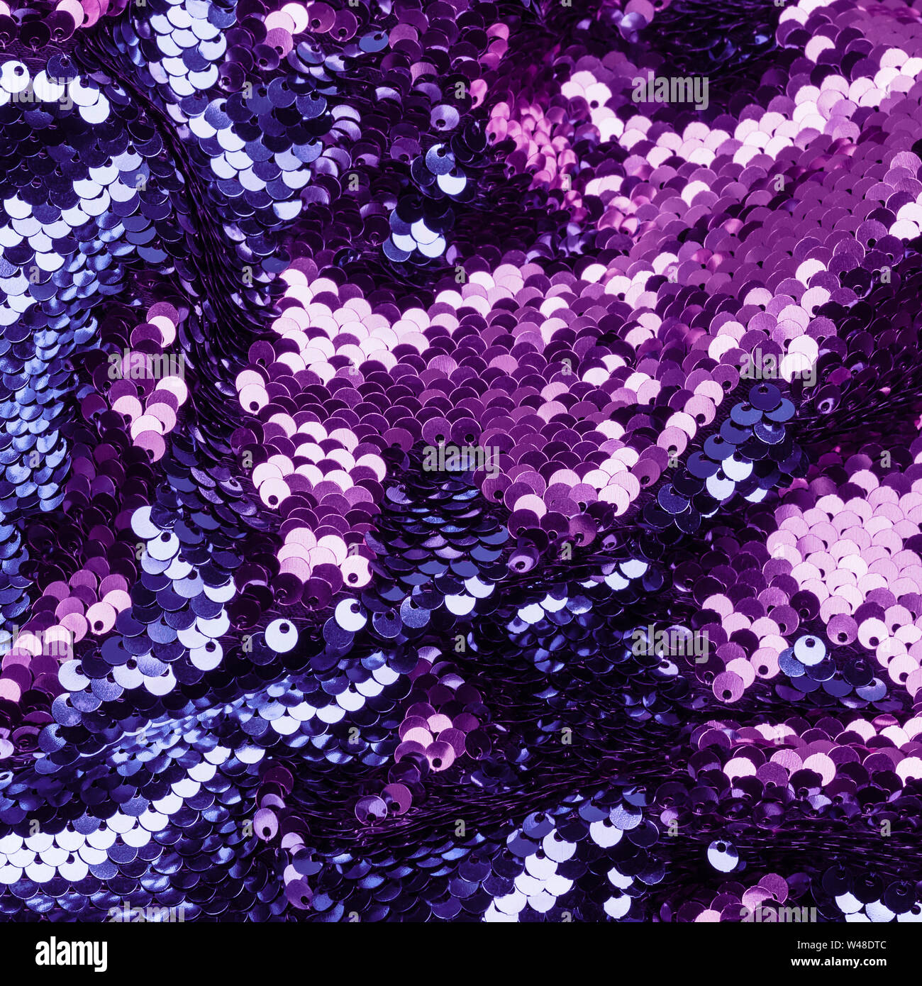 Luxury abstract background with purple iridescent sequins on fabric ...