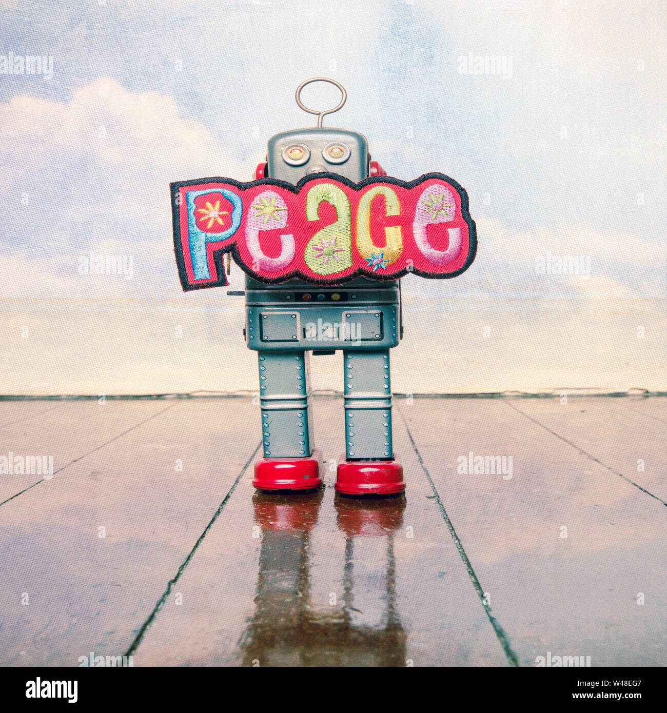 retro robot holds up a pice sign standing on a old wooden floor Stock ...