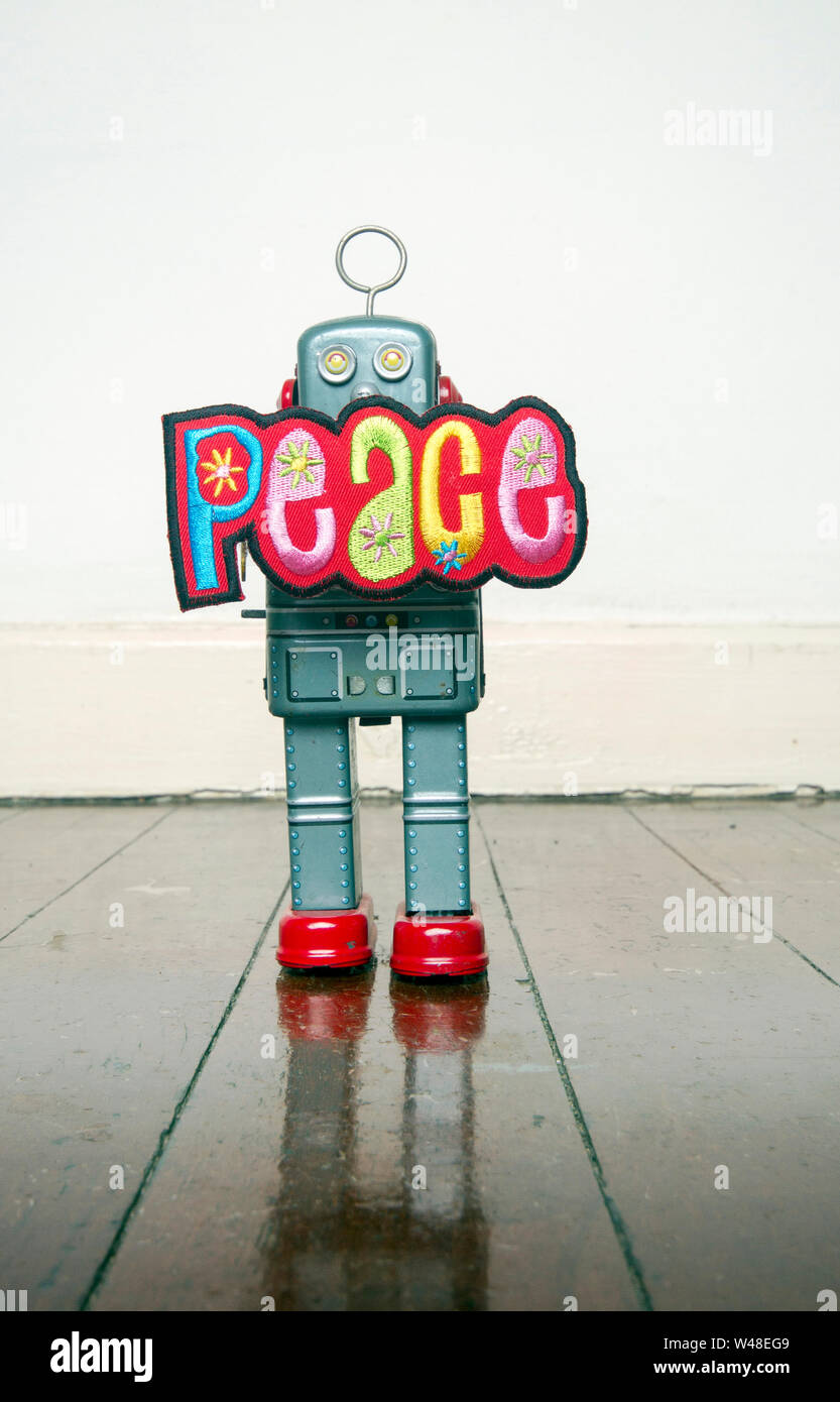 retro robot holds up a pice sign standing on a old wooden floor Stock ...