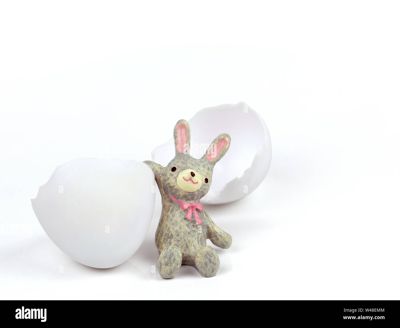 Cute rabbit doll with egg shell broken crack on white background ...