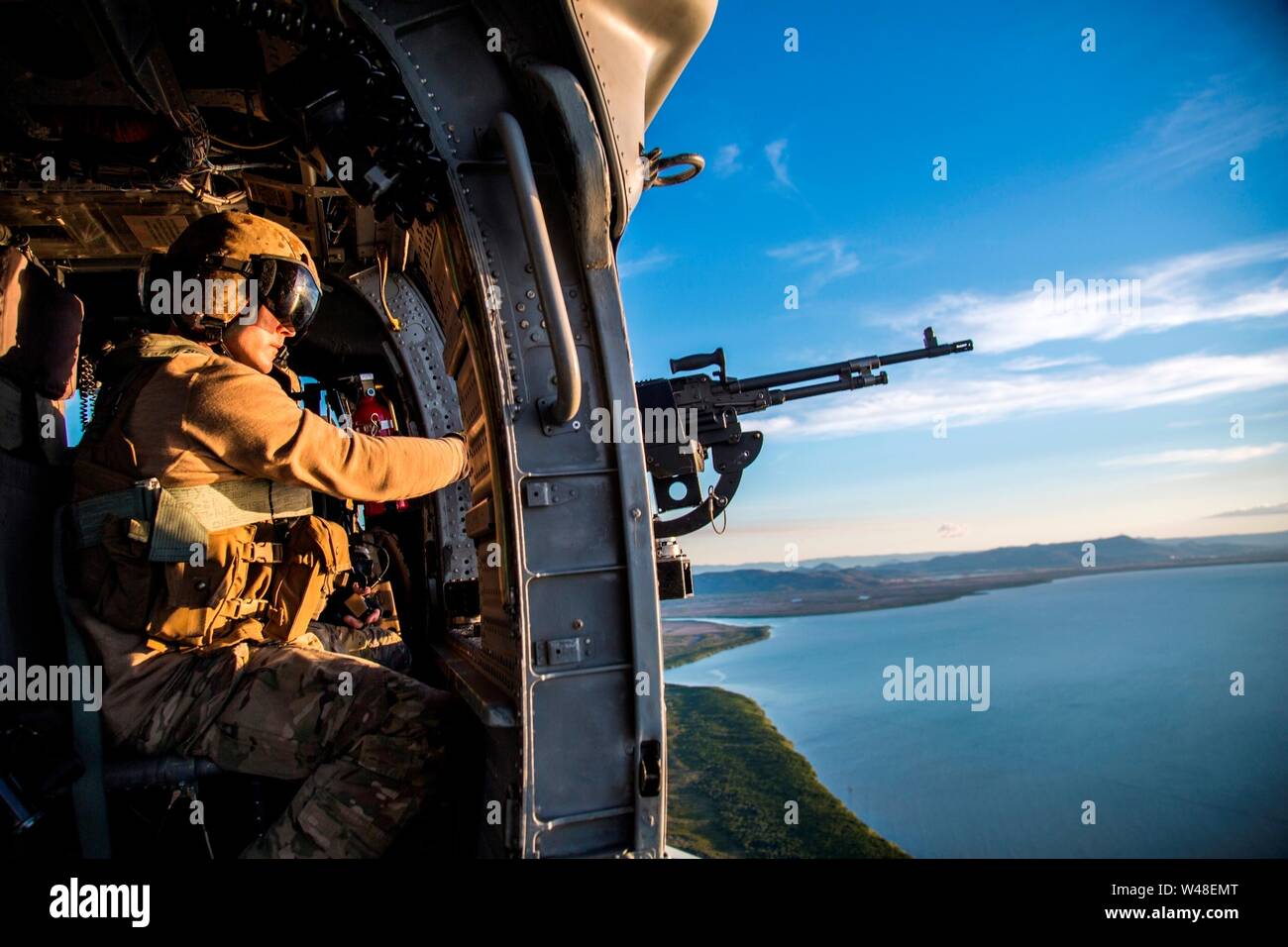 A crew chief with Helicopter Sea Combat Squadron 85 (HSC-85) scans the ...