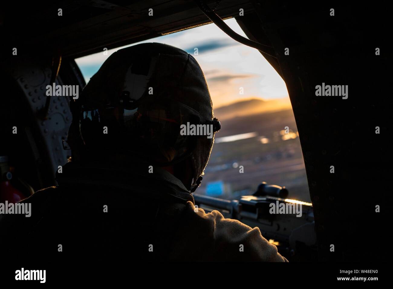 A crew chief with Helicopter Sea Combat Squadron 85 (HSC-85) scans the ...