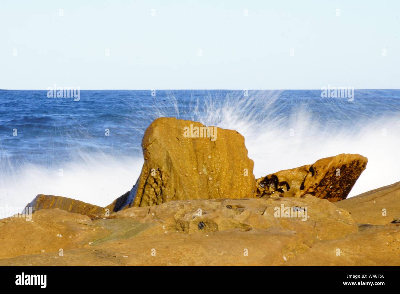 Waves crashing onto rocks Stock Photo - Alamy
