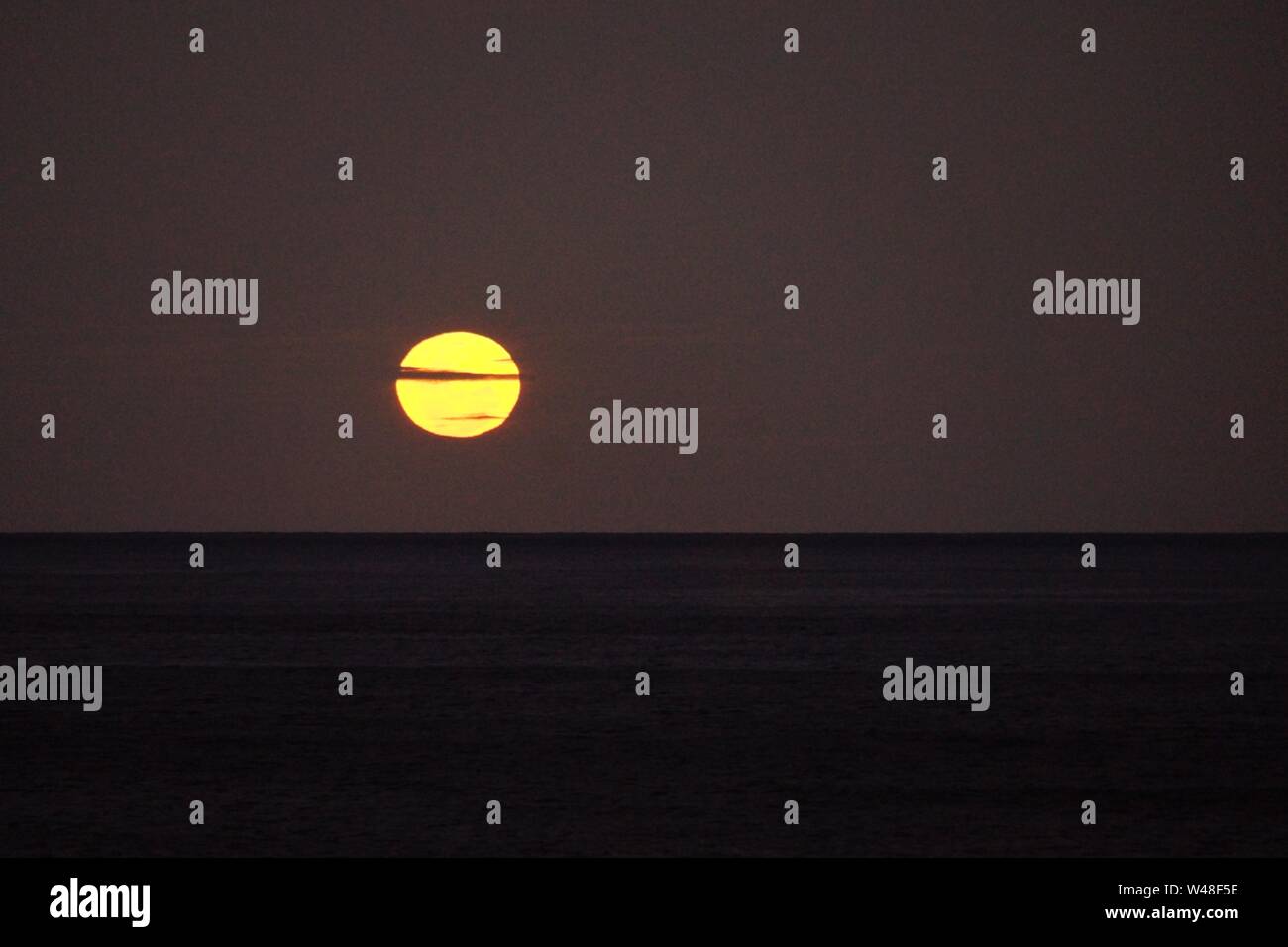 Moon rise and reflection Stock Photo - Alamy