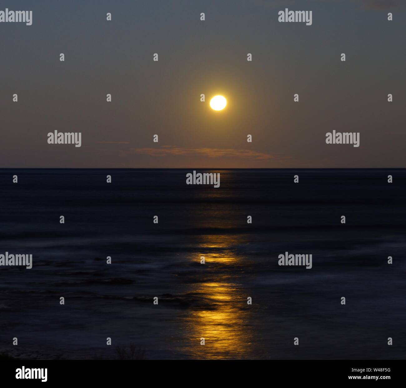 Moon rise and reflection Stock Photo - Alamy
