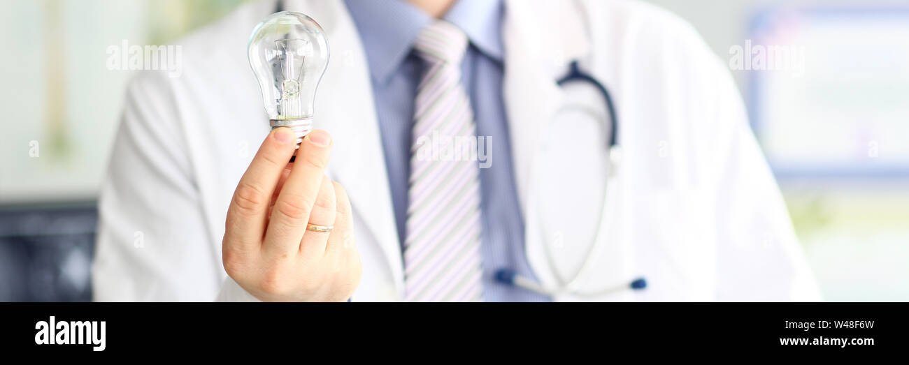 Male doctor hand holding lightbulb as bright idea invention symbol ...