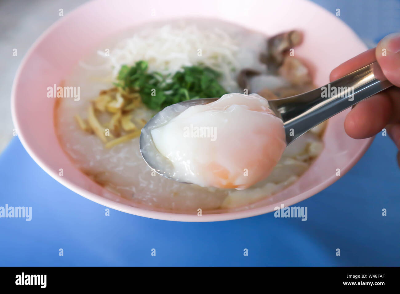 eating rice gruel, rice porridge or congee dish Stock Photo - Alamy