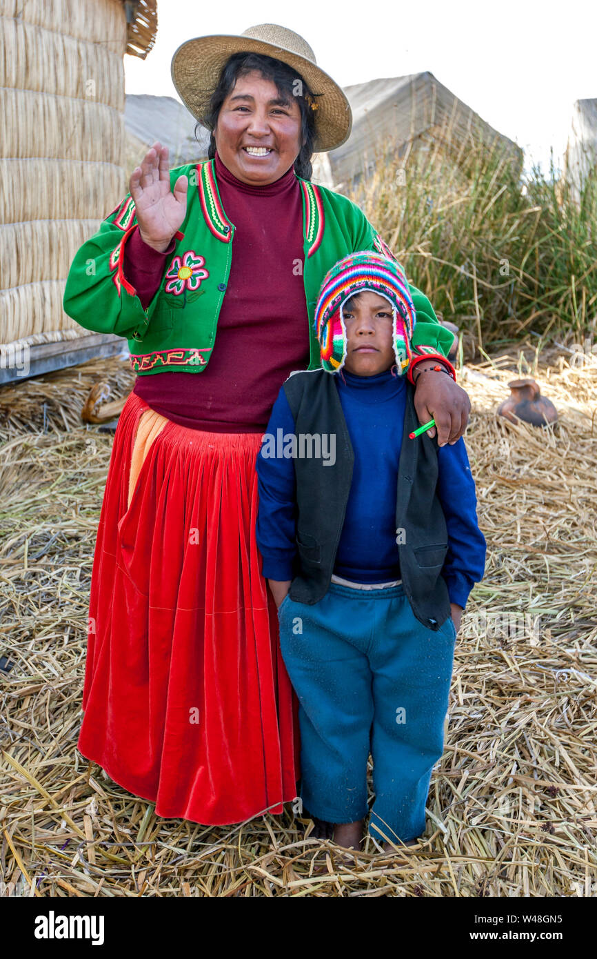 A smiling Peruvian lady with her son who live on one of the 44 floating ...