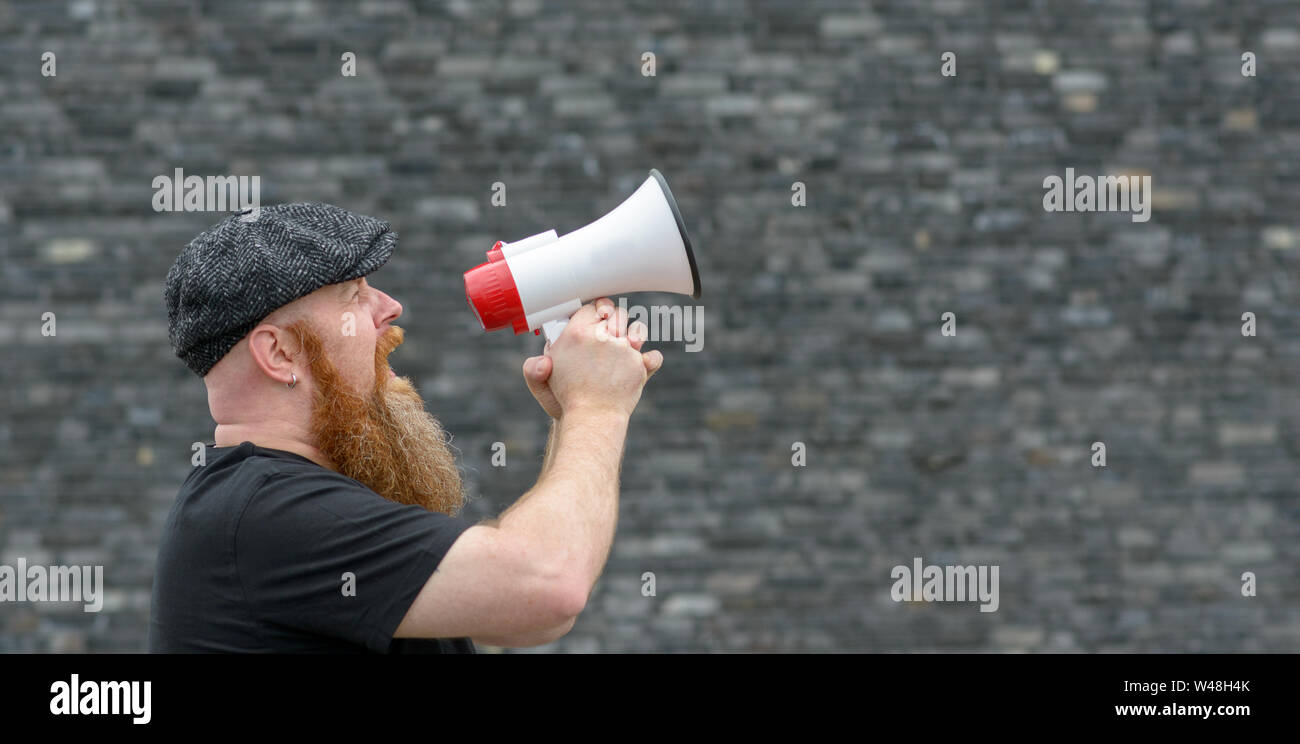 Person speaking megaphone in protest hi-res stock photography and ...