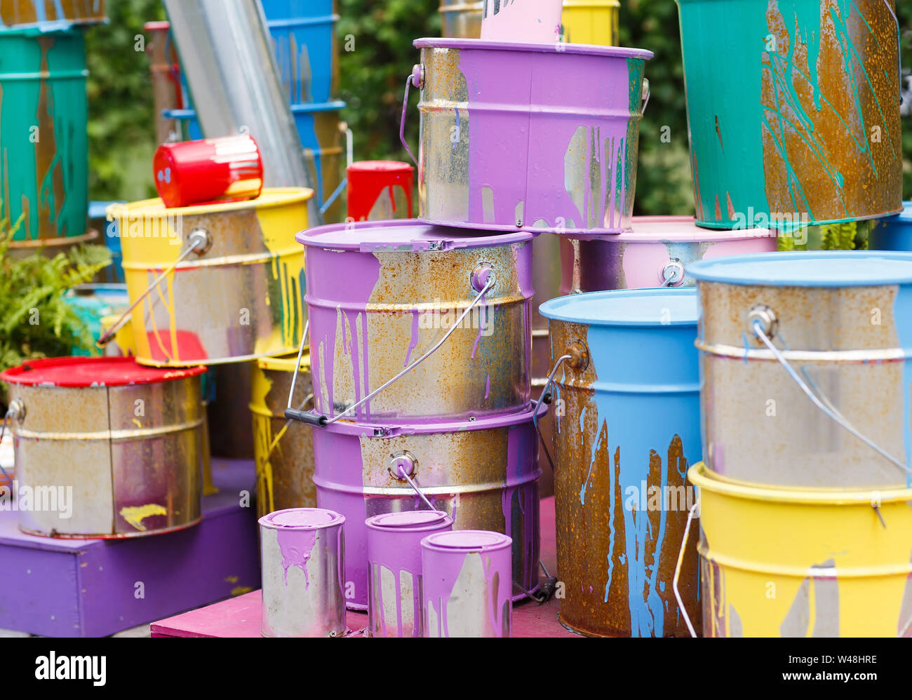 The used paint cans. Colorful paint buckets Stock Photo - Alamy