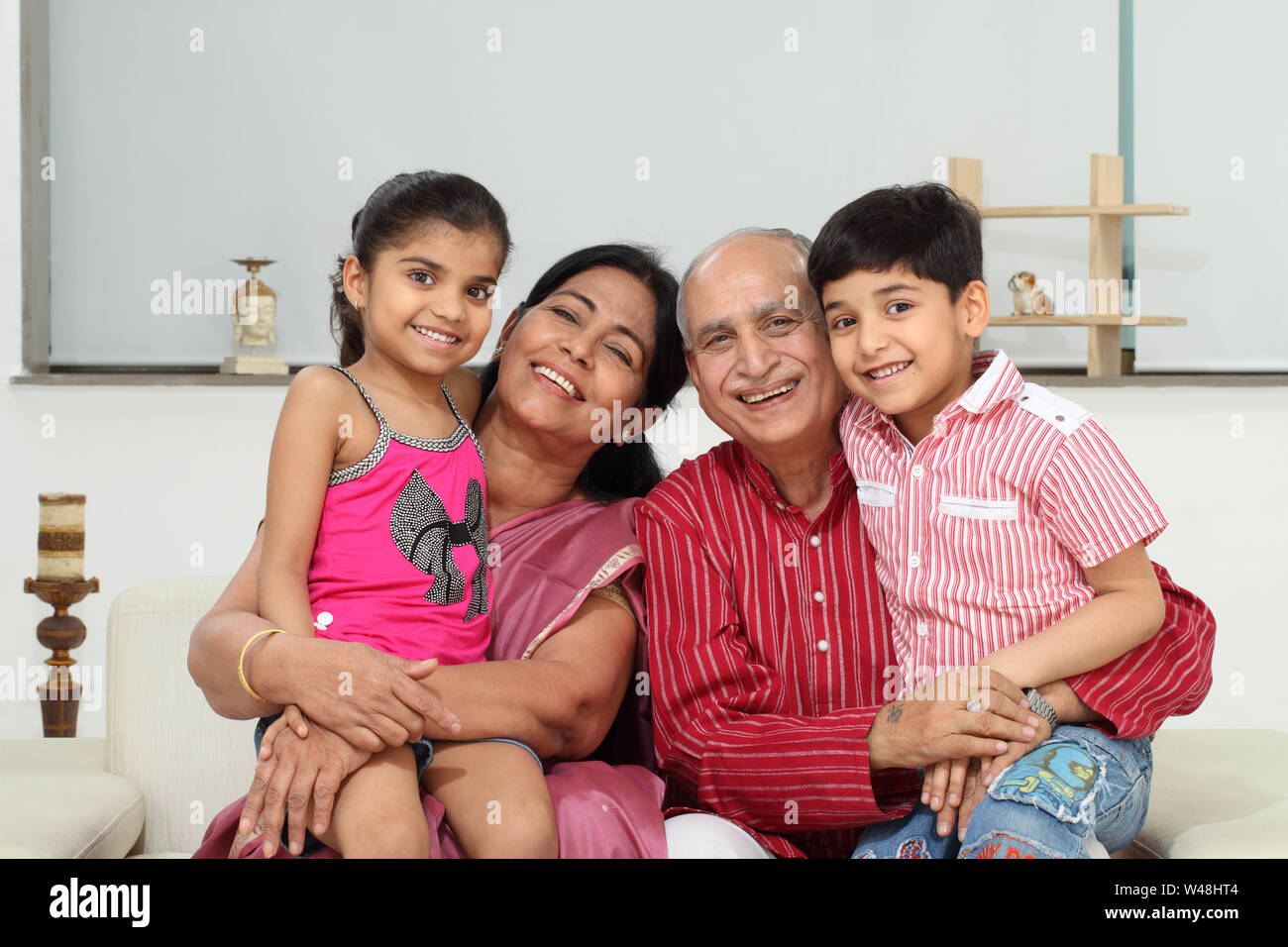 Portrait of a family smiling at home Stock Photo - Alamy