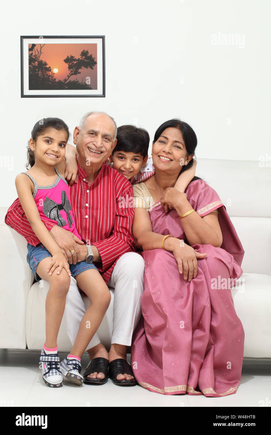 Portrait of a family smiling at home Stock Photo - Alamy