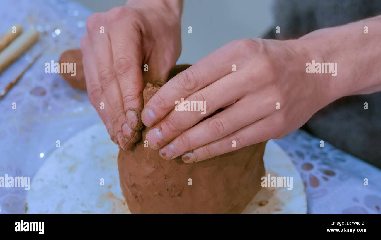Professional male potter making ceramic jug Stock Photo - Alamy