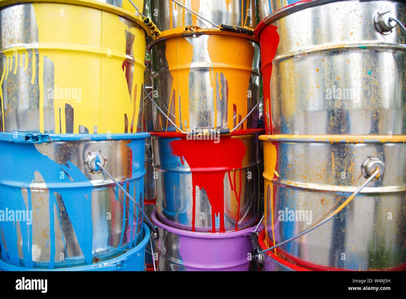 The used paint cans. Colorful paint buckets Stock Photo - Alamy