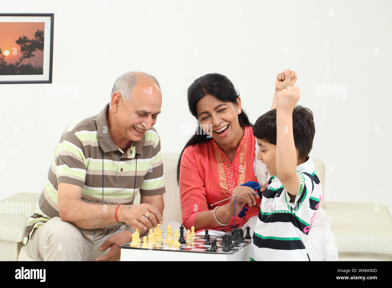 Old man playing chess with his grandson at home Stock Photo - Alamy
