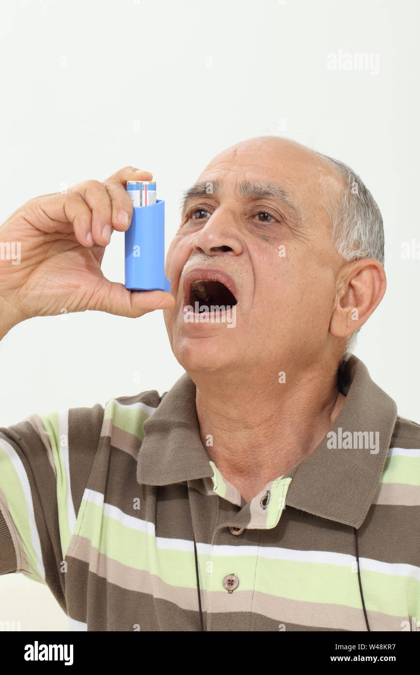 Old man using asthma inhaler Stock Photo - Alamy