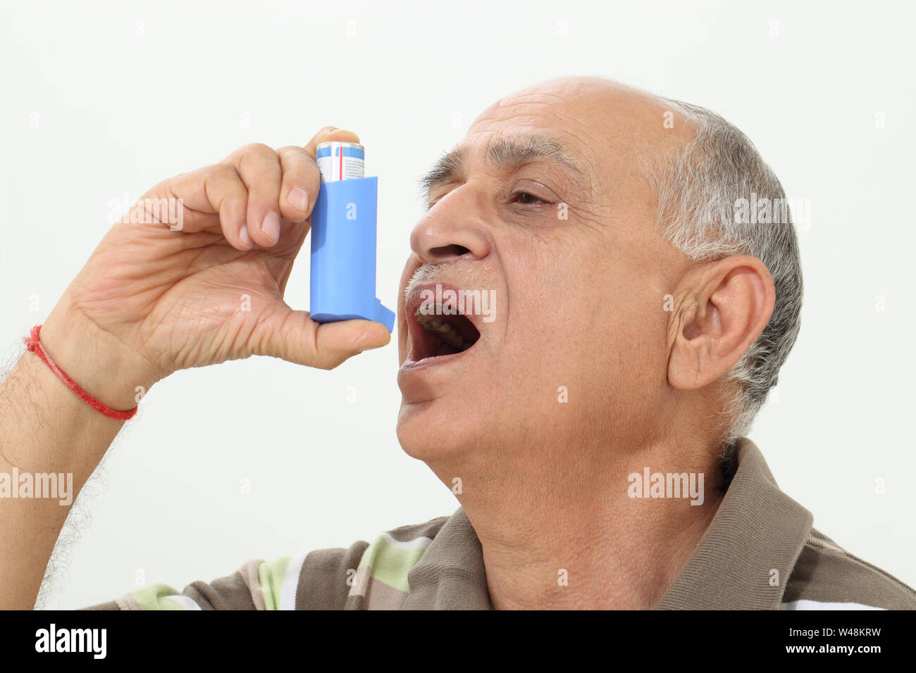 Old man using asthma inhaler Stock Photo - Alamy
