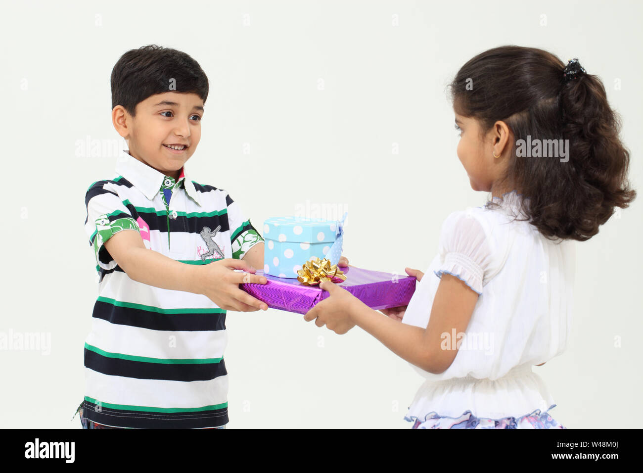 Boy giving gifts to his sister Stock Photo - Alamy
