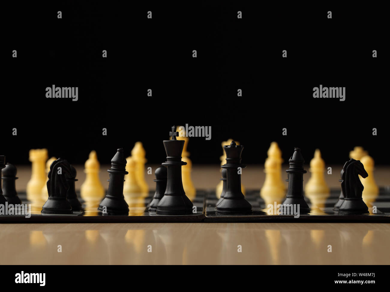 Chess pieces on a checkered board Stock Photo - Alamy