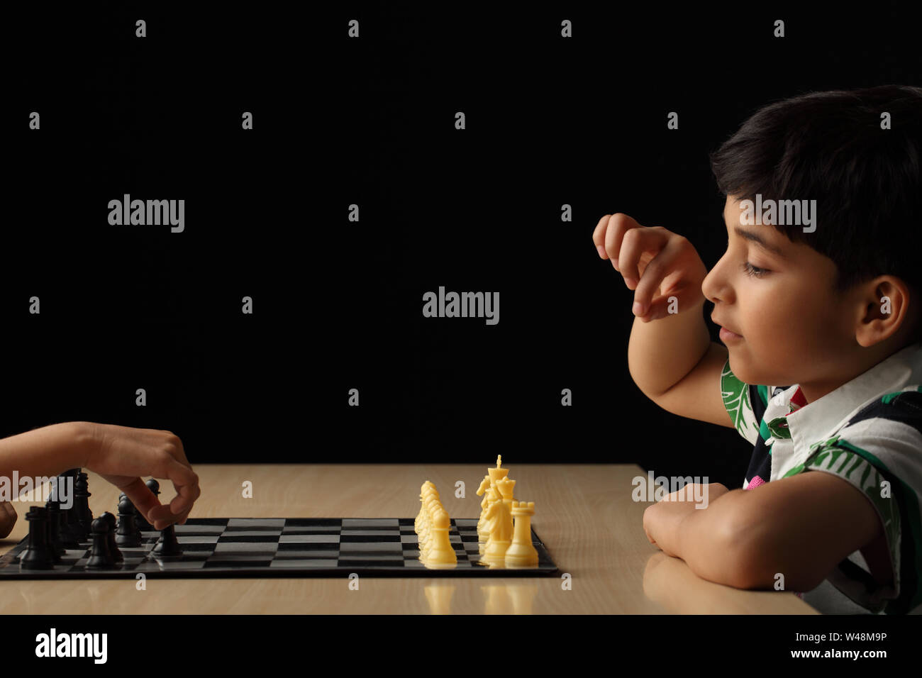 Boy playing chess Stock Photo - Alamy