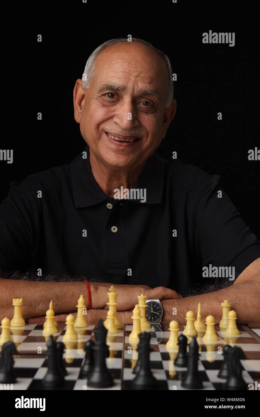 Senior man playing chess Stock Photo - Alamy
