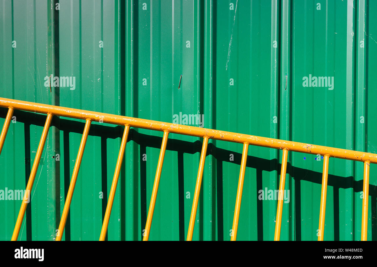 green color metal wall and yellow barrier Stock Photo - Alamy