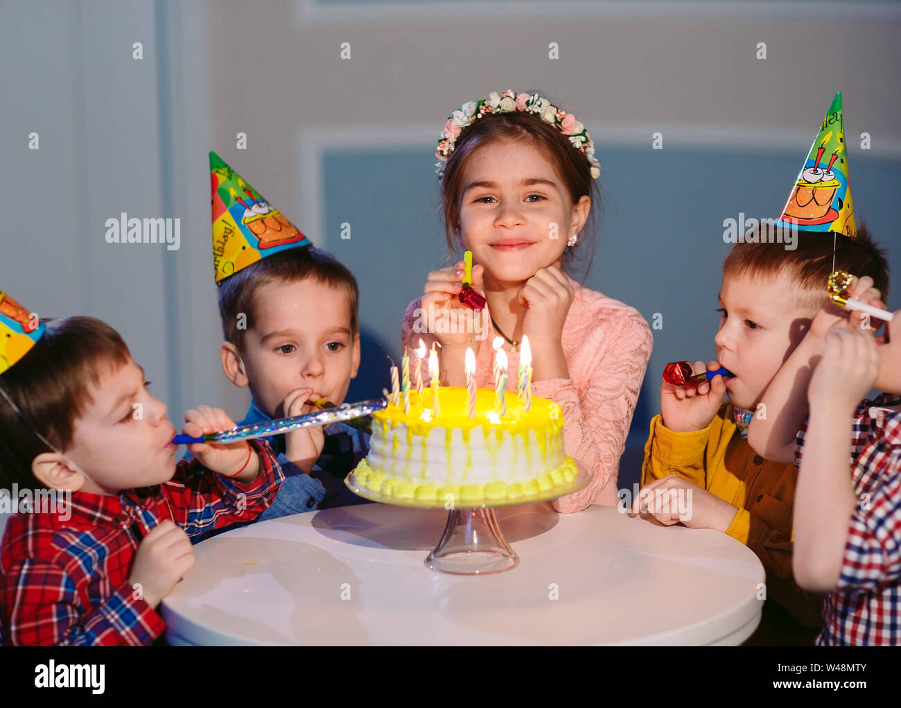 Children's birthday. Children near a birthday cake with candles Stock ...