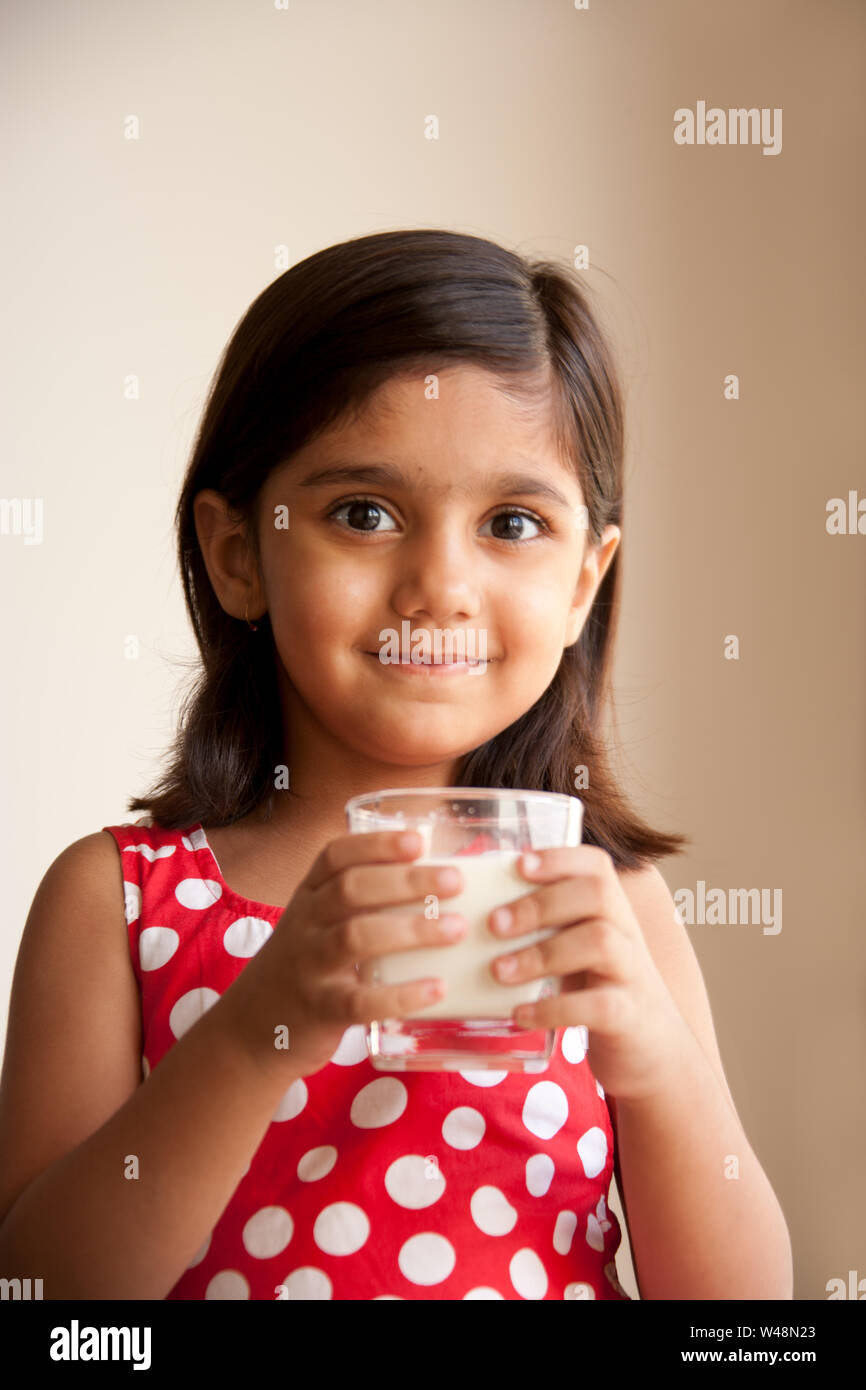 Indian girl drinking glass milk hi-res stock photography and images - Alamy
