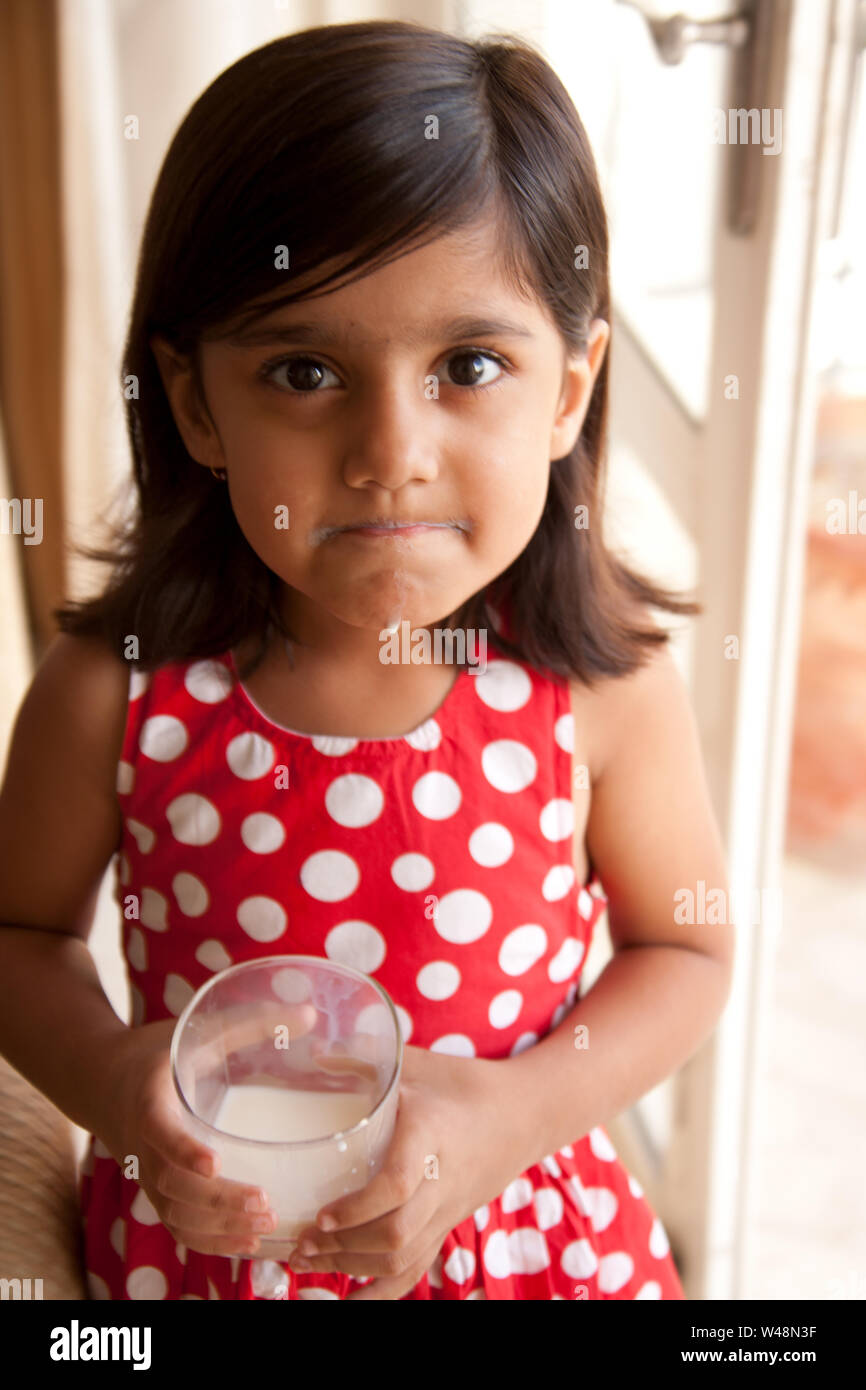Indian girl drinking glass milk hi-res stock photography and images - Alamy