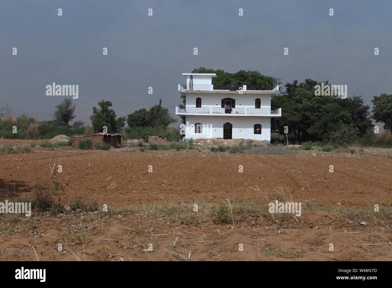 Rural house in a field Stock Photo - Alamy