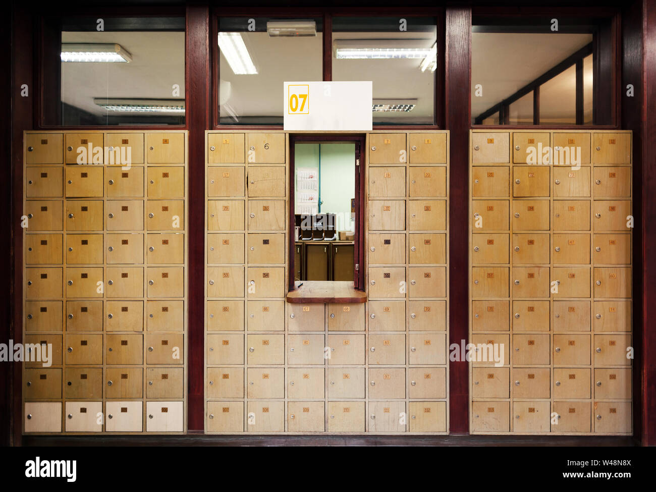 Details of interior of an old post office, wooden boxes and counter ...