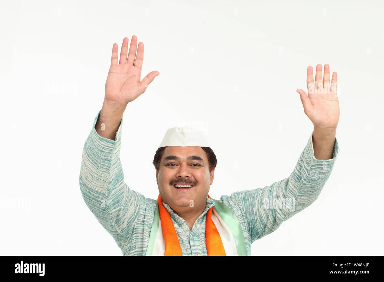 Politician smiling with his arms raised Stock Photo - Alamy